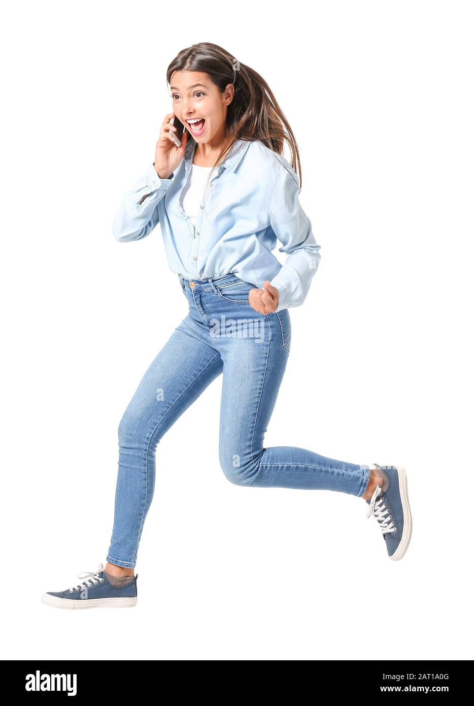 Jumping woman talking by mobile phone on white background Stock Photo ...