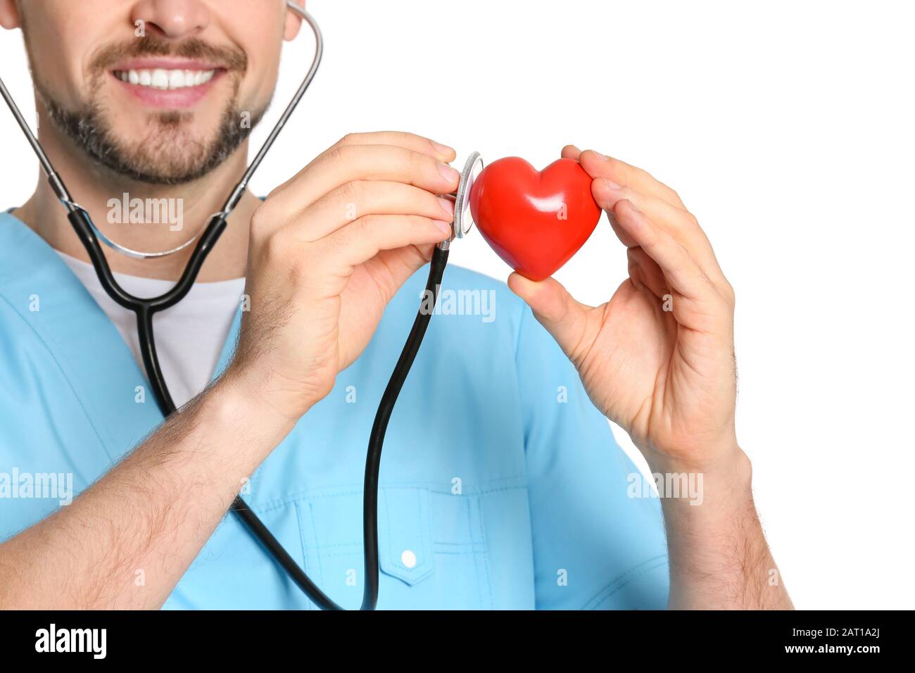 Male cardiologist with red heart on white background Stock Photo - Alamy