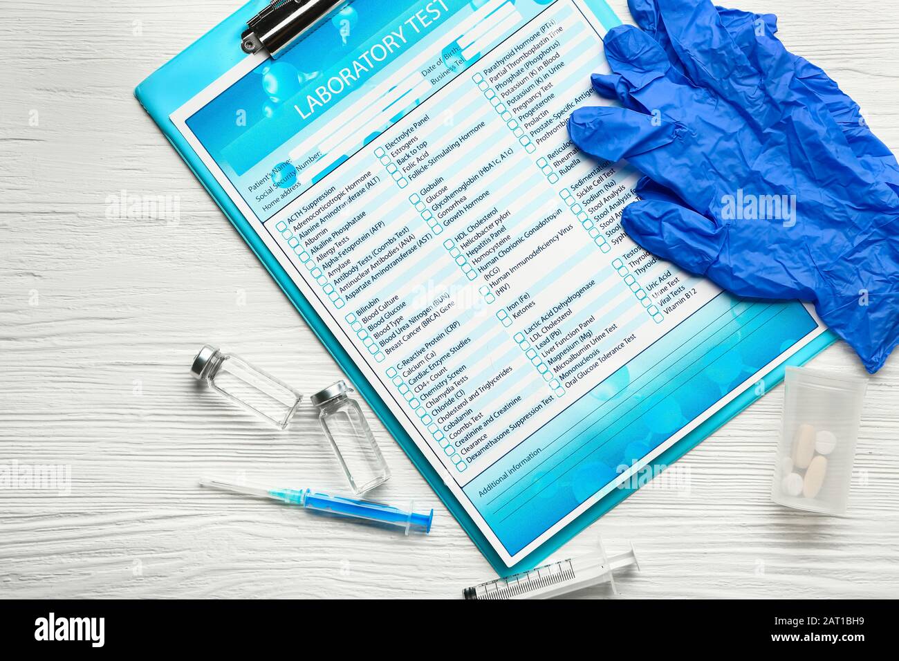 Laboratory test form with gloves and medicines on white table Stock ...