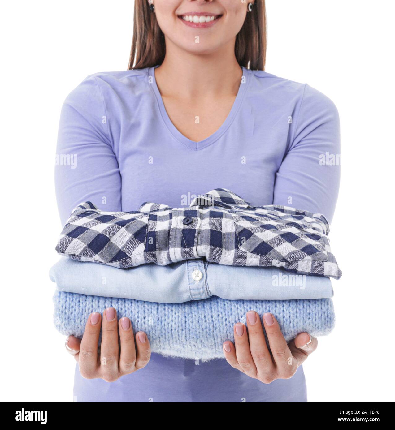 Young woman with clean laundry on white background Stock Photo - Alamy