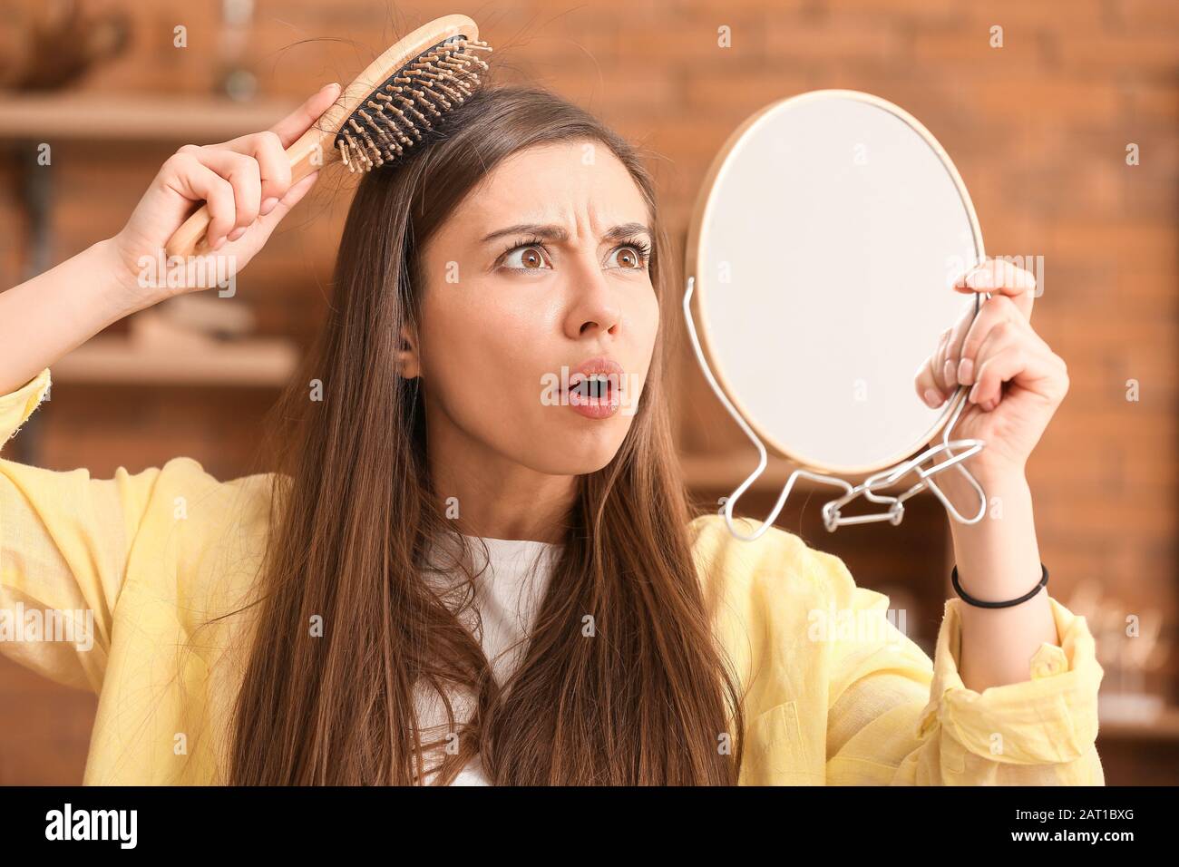Woman brushing hair worried hi-res stock photography and images - Alamy