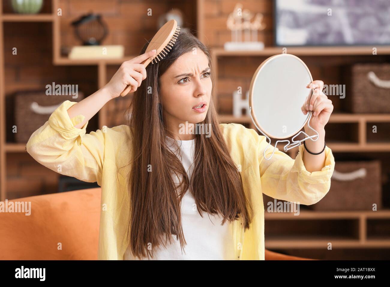 Woman brushing hair worried hi-res stock photography and images - Alamy