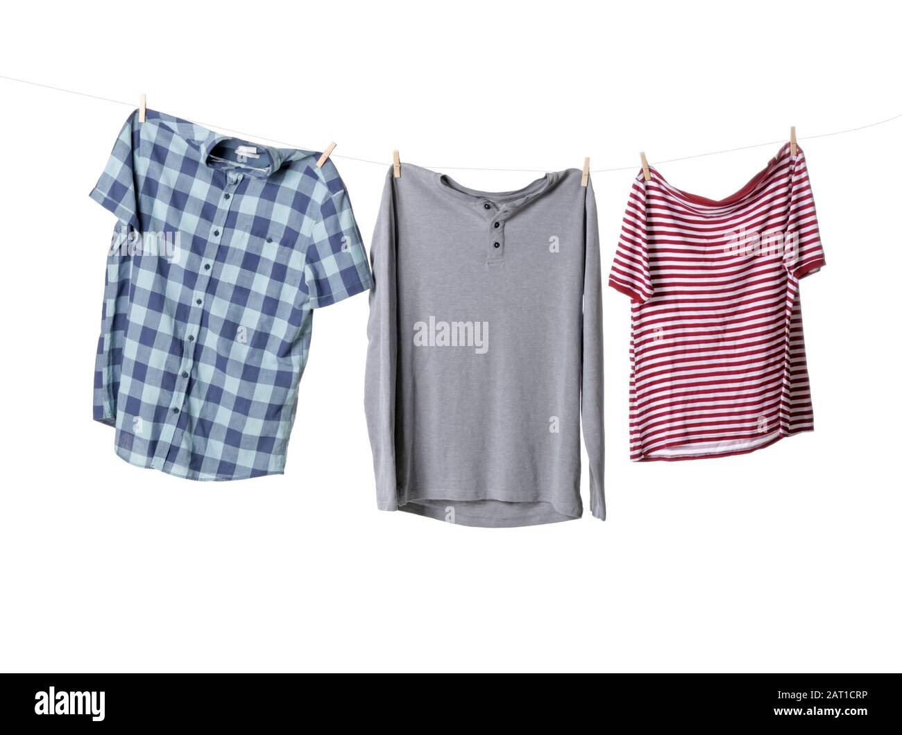 Clean clothes hanging on rope against white background Stock Photo - Alamy