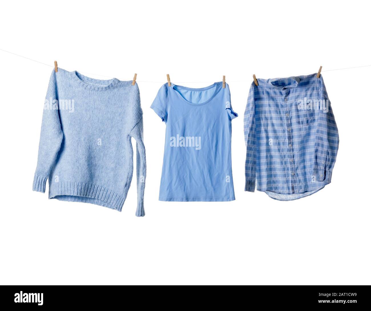 Clean clothes hanging on rope against white background Stock Photo - Alamy