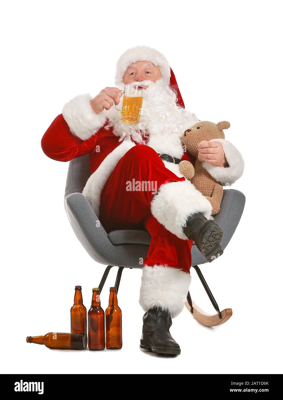 Funny drunk Santa Claus sitting in armchair on white background Stock ...
