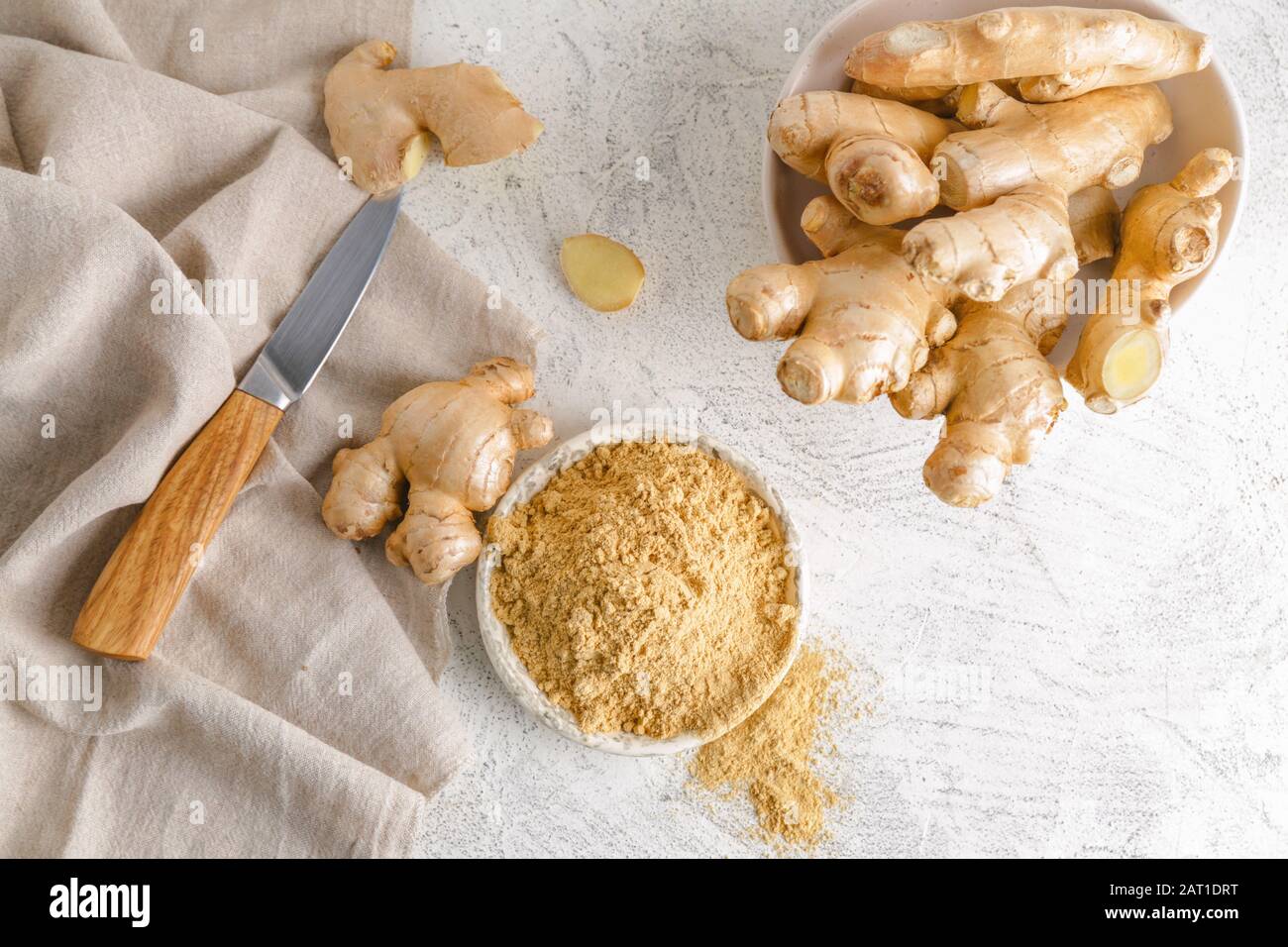 Fresh and ground ginger on white background Stock Photo - Alamy