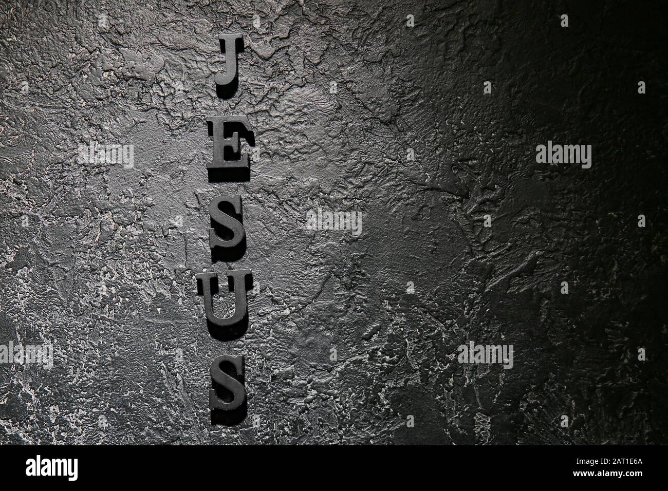 Word JESUS on dark background Stock Photo - Alamy