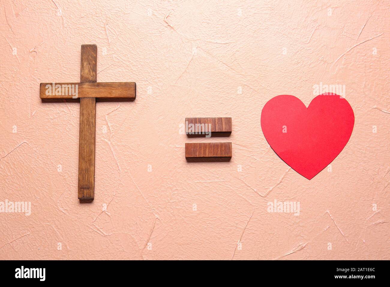 Christian cross and heart on color background Stock Photo - Alamy