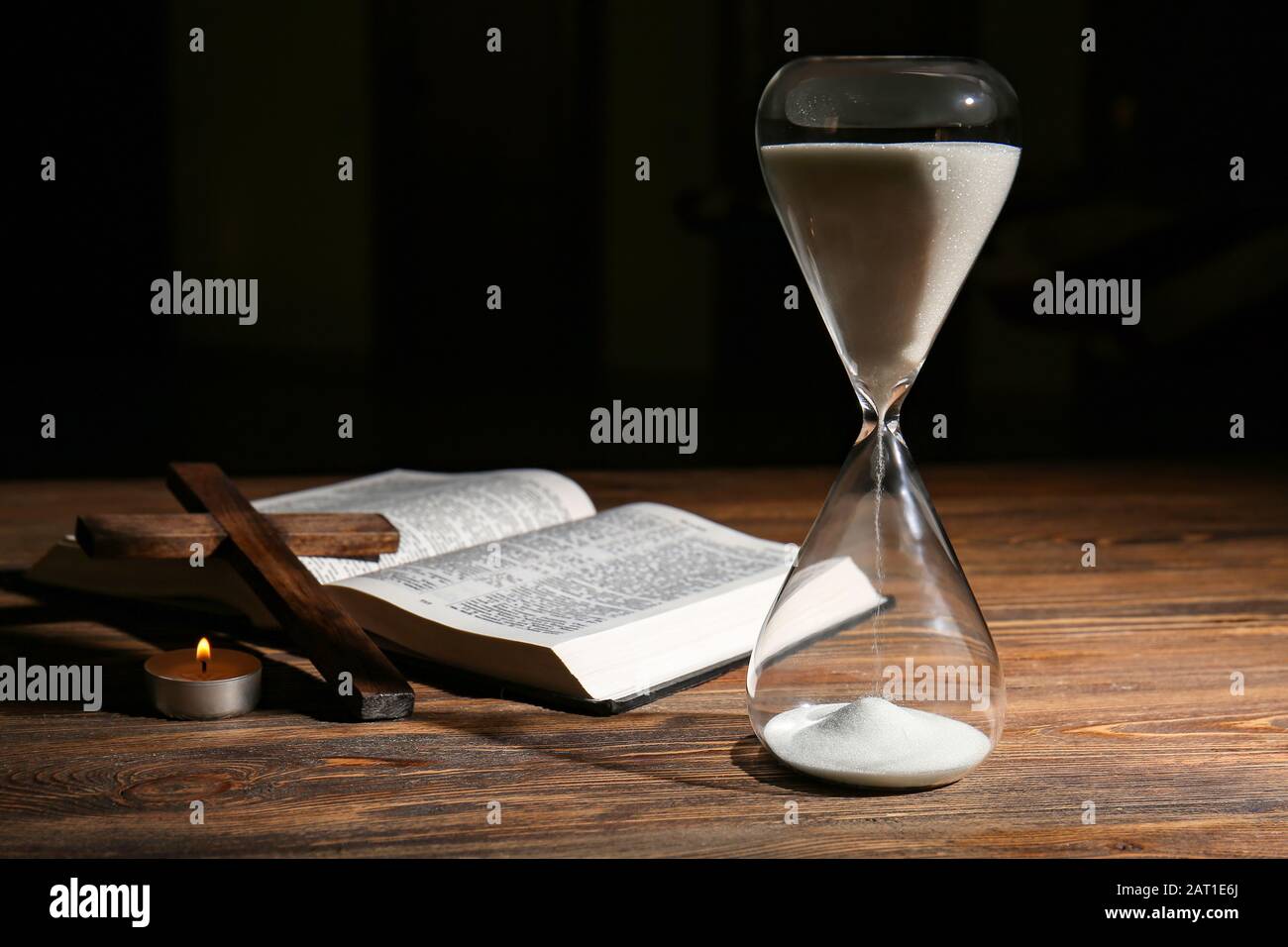 Hourglass, Bible and cross on wooden background Stock Photo - Alamy