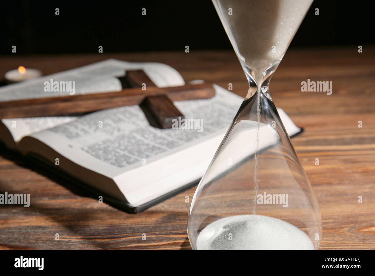 Hourglass, Bible and cross on wooden background Stock Photo - Alamy