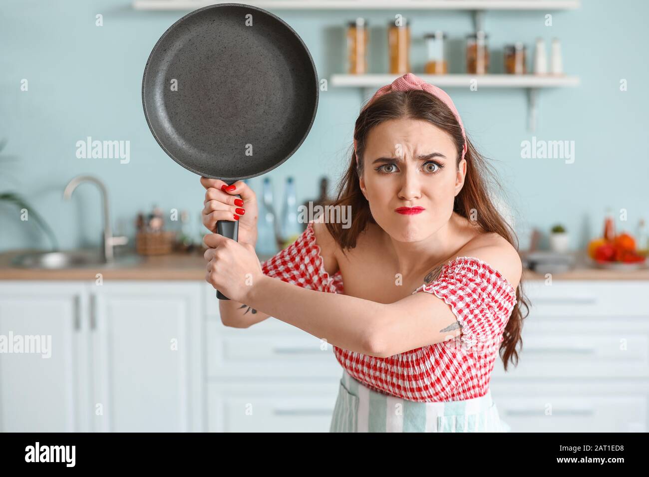 Funny angry housewife in kitchen Stock Photo - Alamy