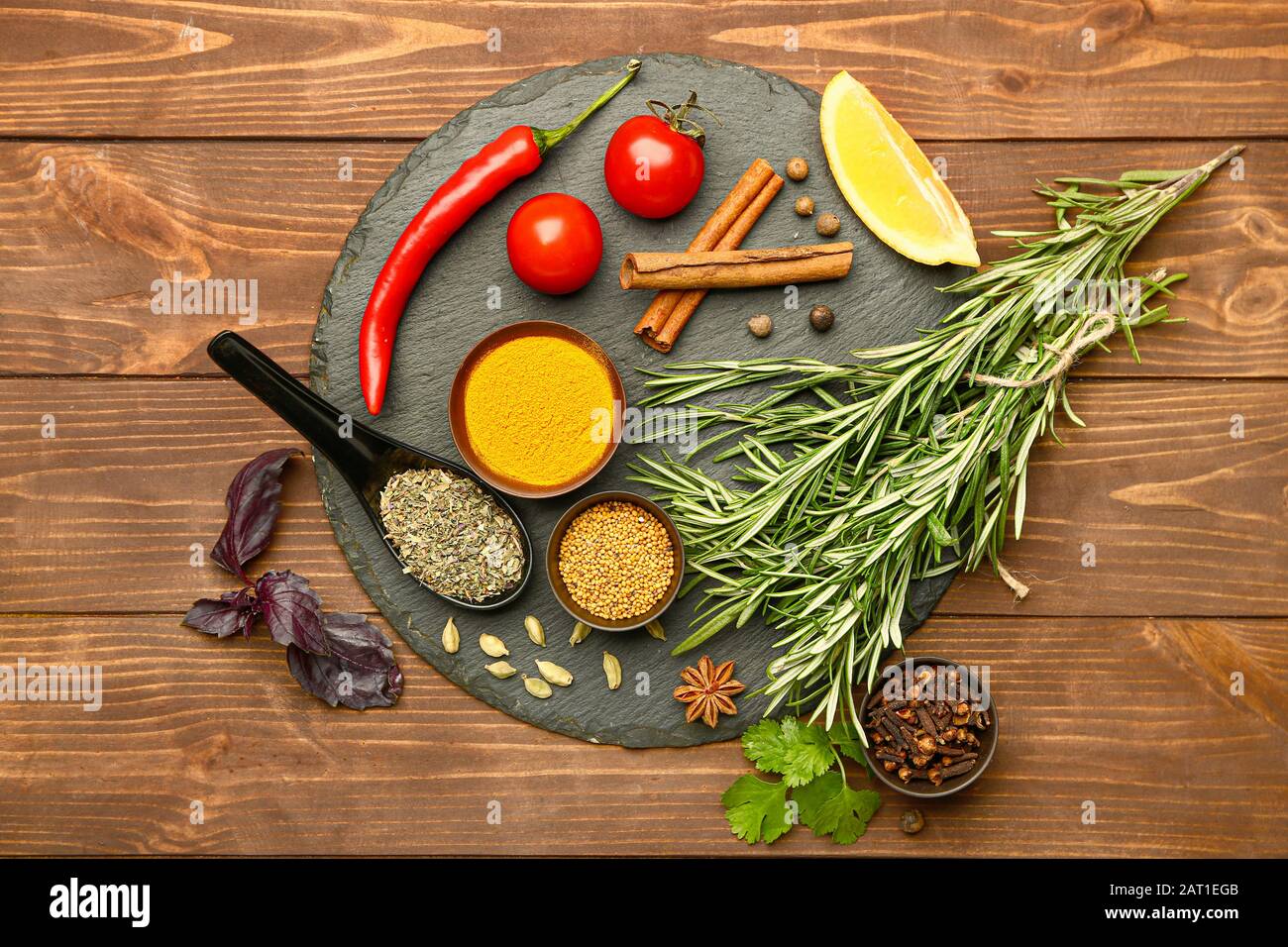 Many different spices on wooden background Stock Photo - Alamy