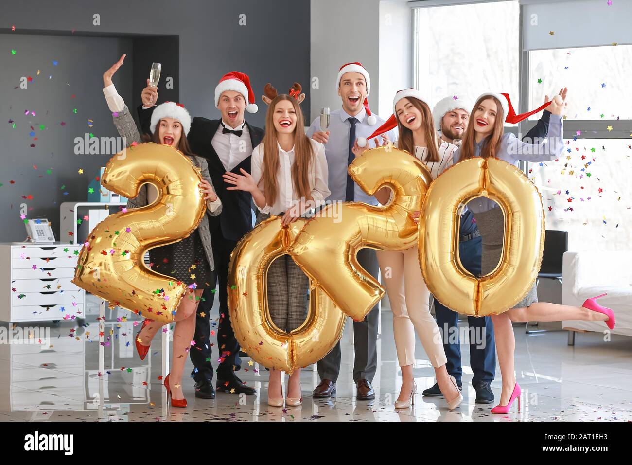 Colleagues at New Year party in office Stock Photo - Alamy