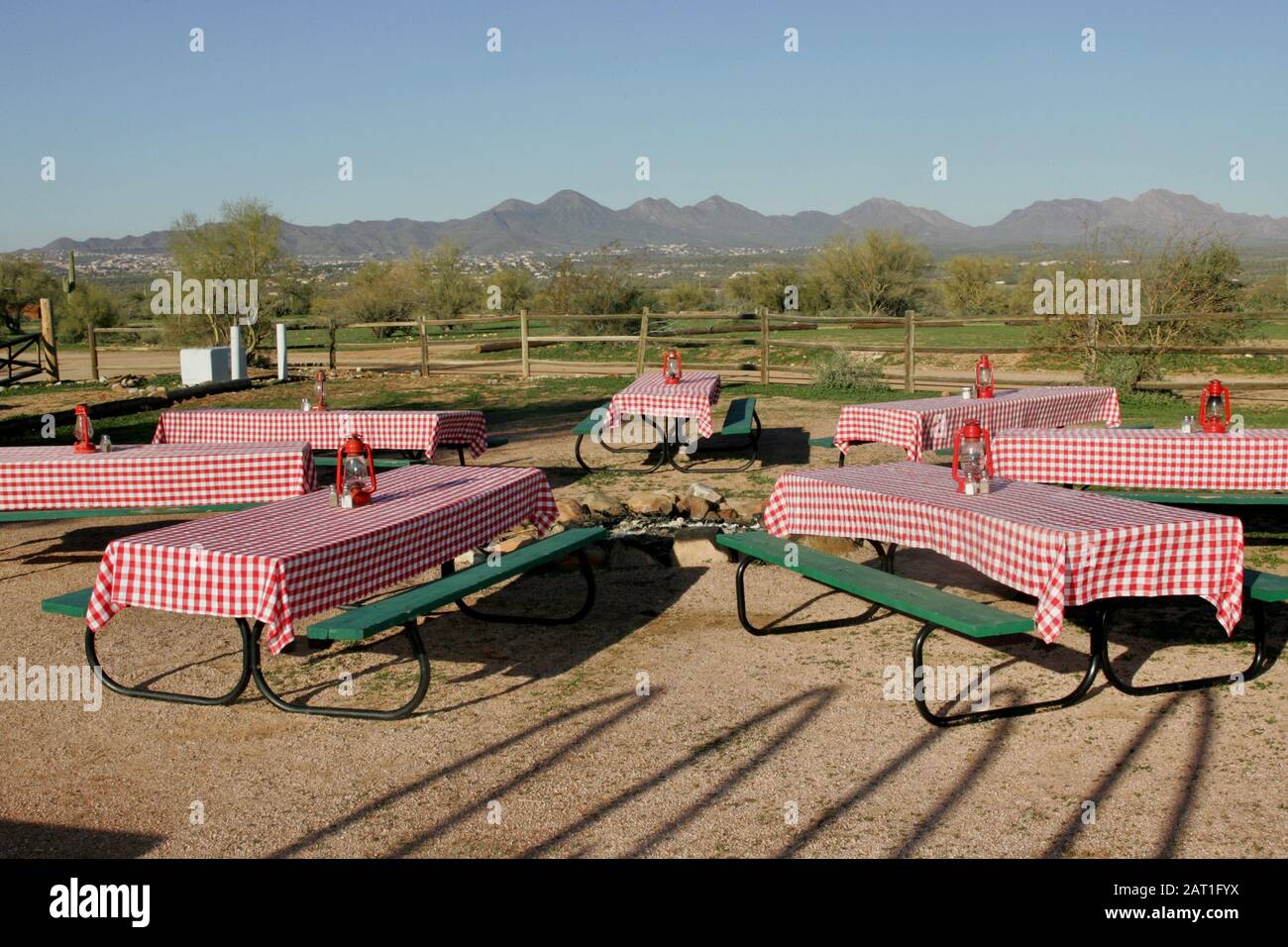 A cowboy lunch ready with picnic tables set in the desert Stock Photo ...