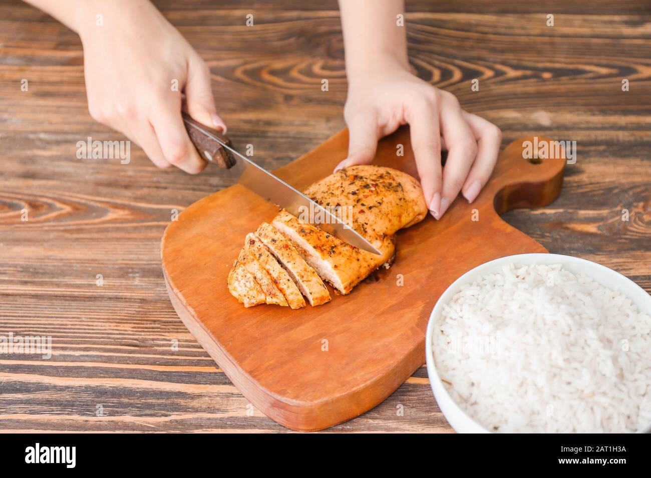 Woman preparing chicken dish hi-res stock photography and images - Alamy