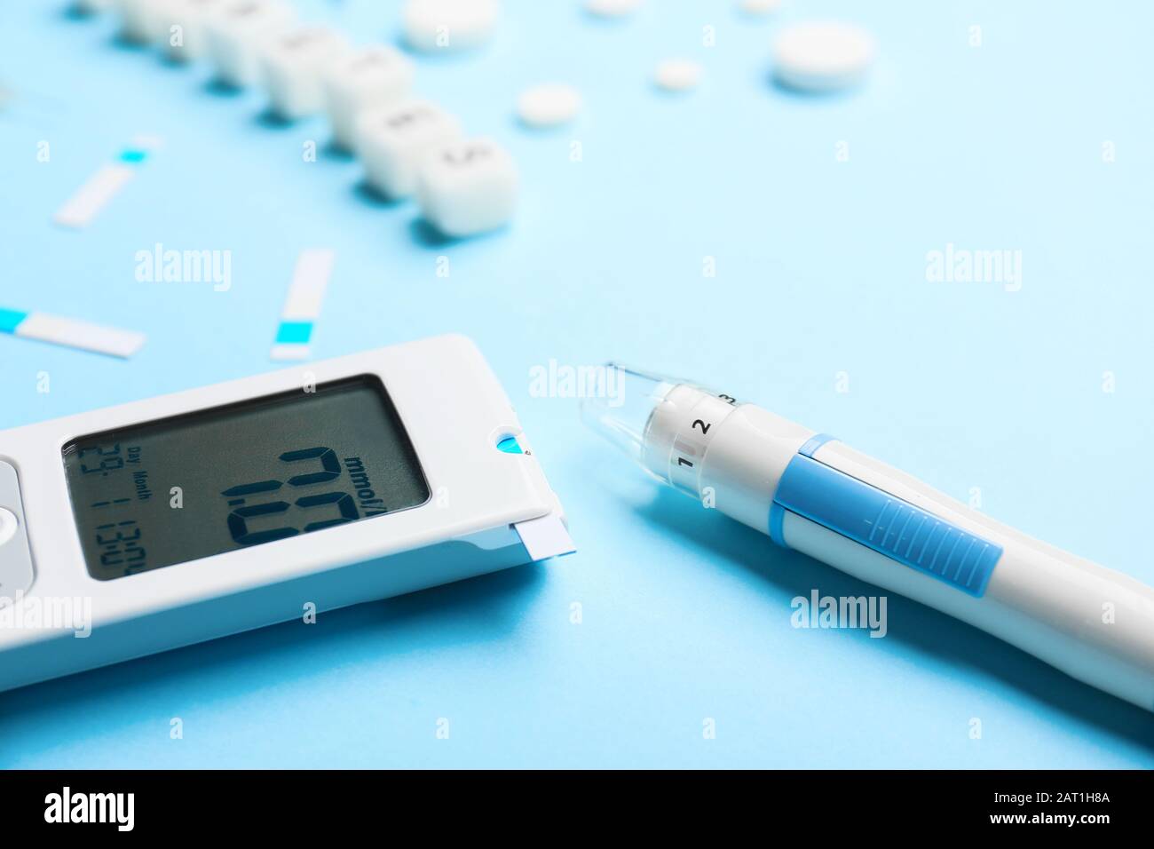 Glucometer and lancet pen on color background. Diabetes concept Stock ...