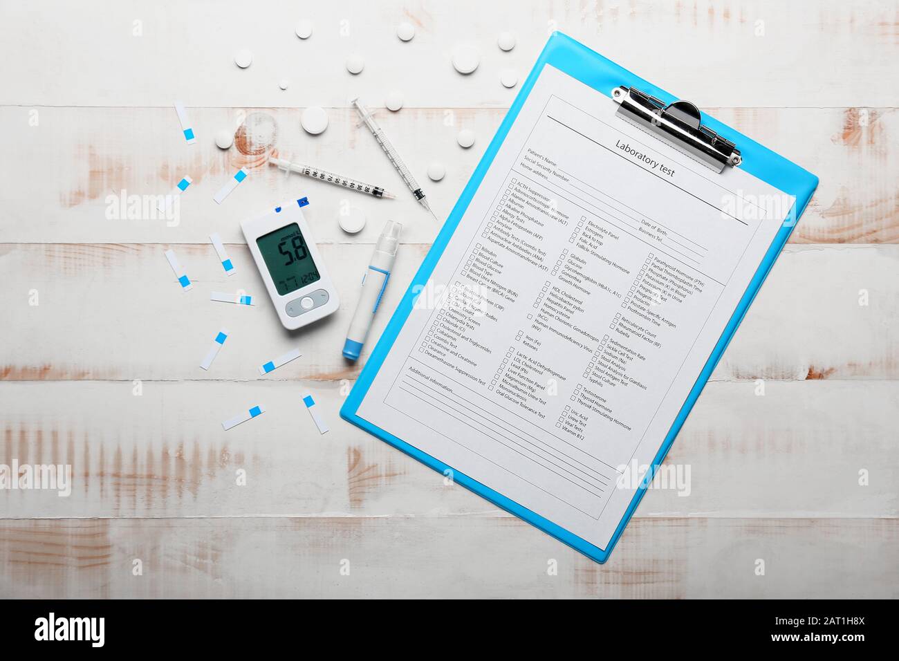 Laboratory test, glucometer, pills, syringes and lancet pen on table ...