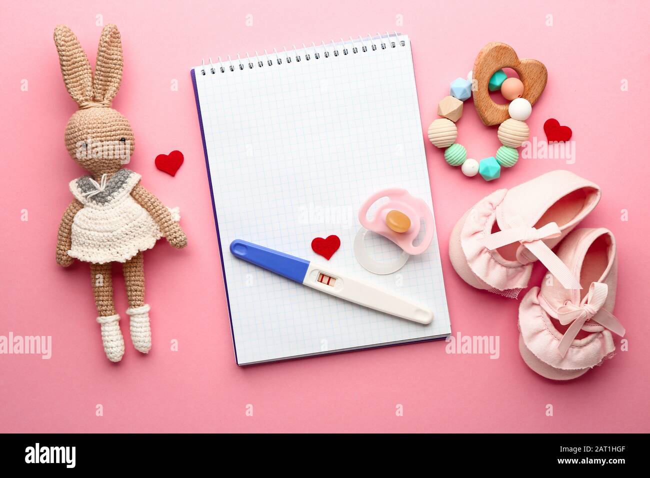Pregnancy test, notebook, toys and pacifier on color background Stock ...