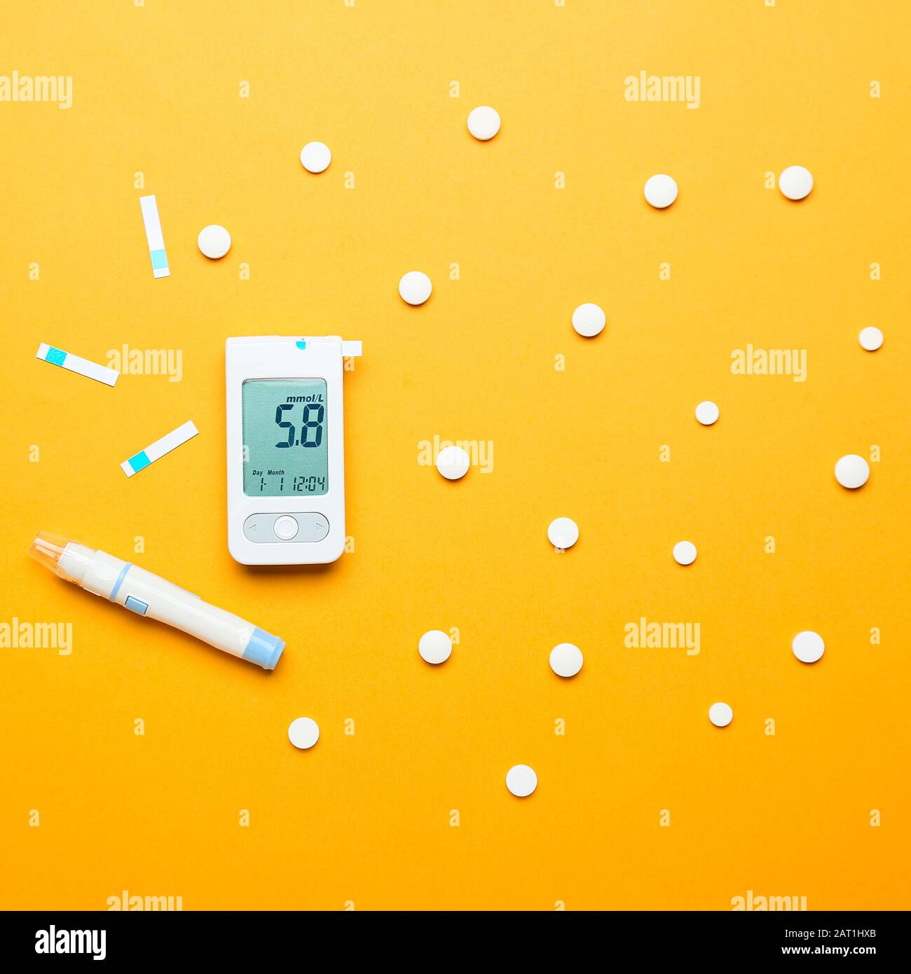 Digital glucometer, lancet pen and pills on color background. Diabetes ...