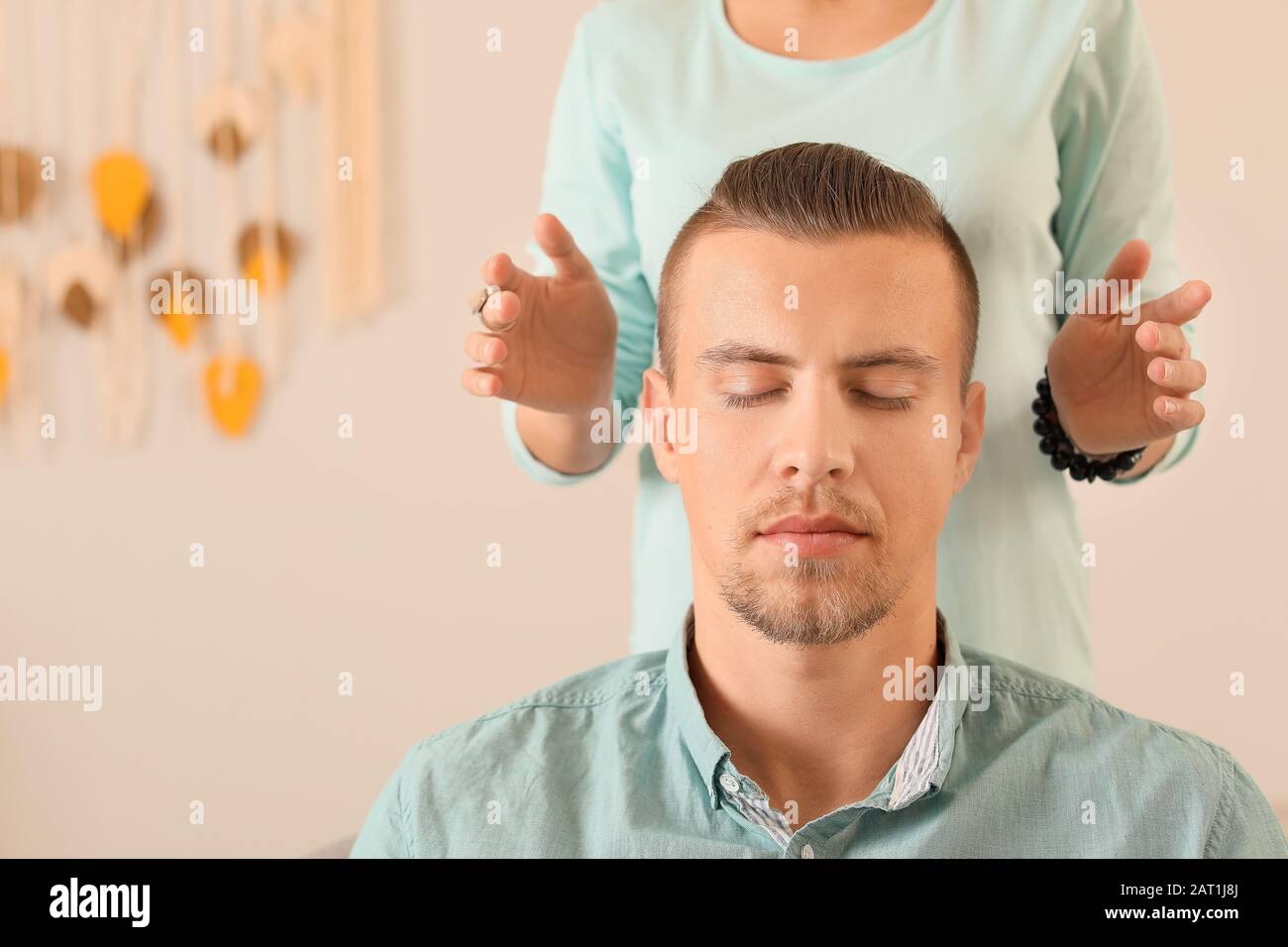 Reiki master working with patient Stock Photo - Alamy