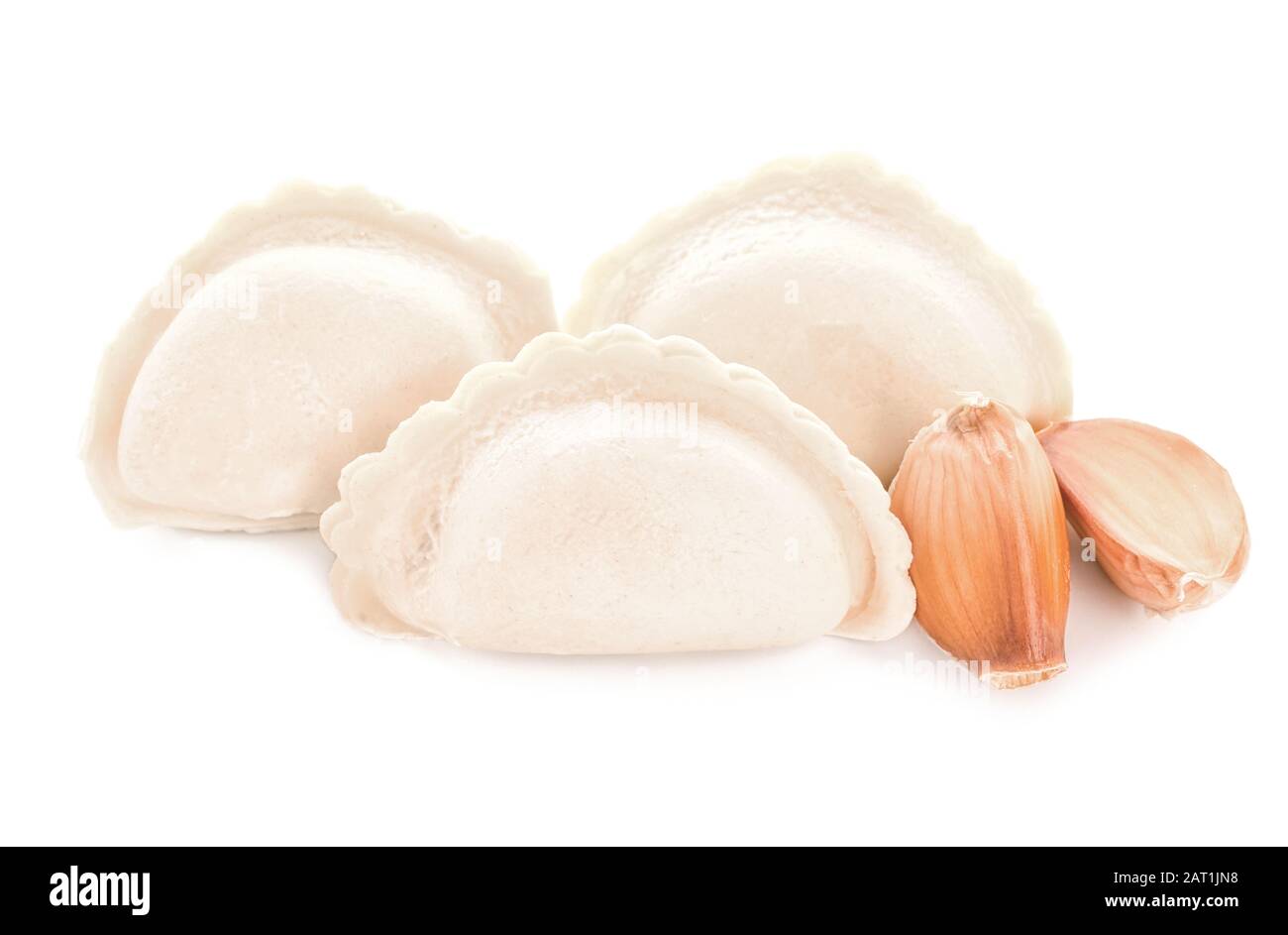 Raw dumplings with garlic on white background Stock Photo - Alamy
