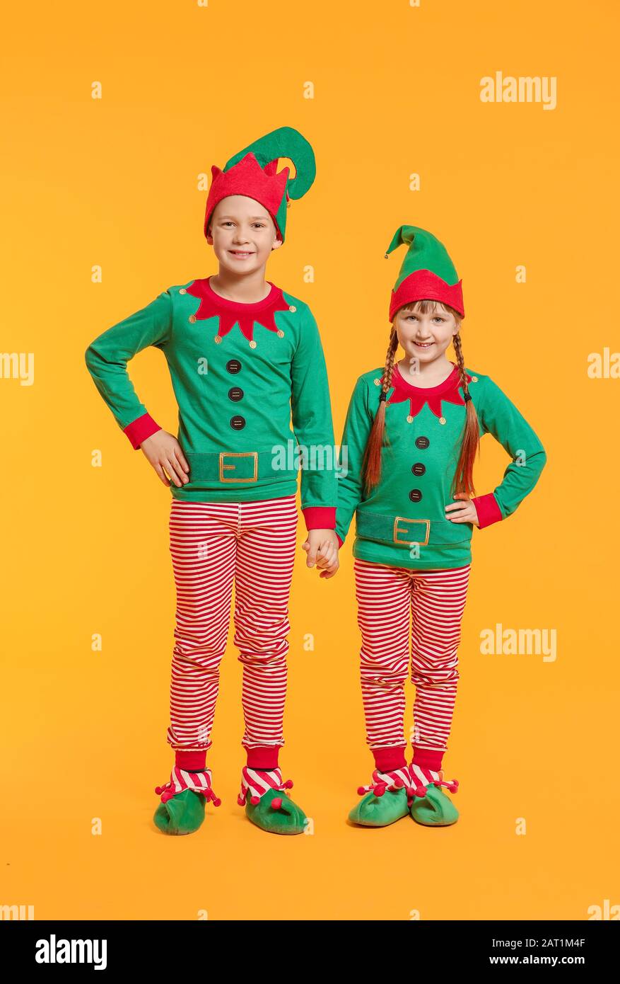 Little children in costume of elf on color background Stock Photo - Alamy