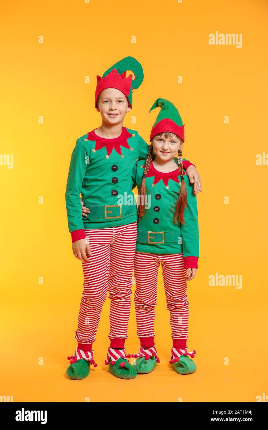 Little children in costume of elf on color background Stock Photo - Alamy