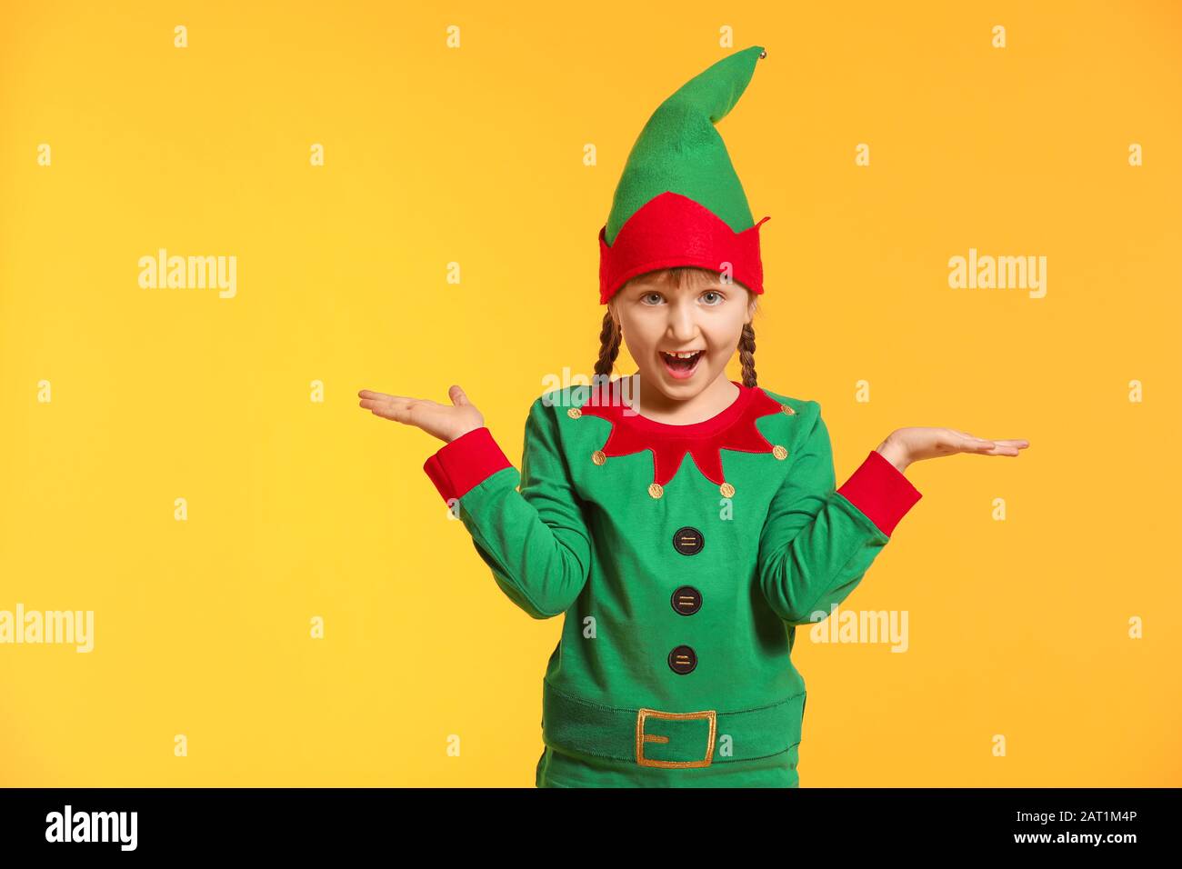Surprised girl in costume of elf on color background Stock Photo - Alamy