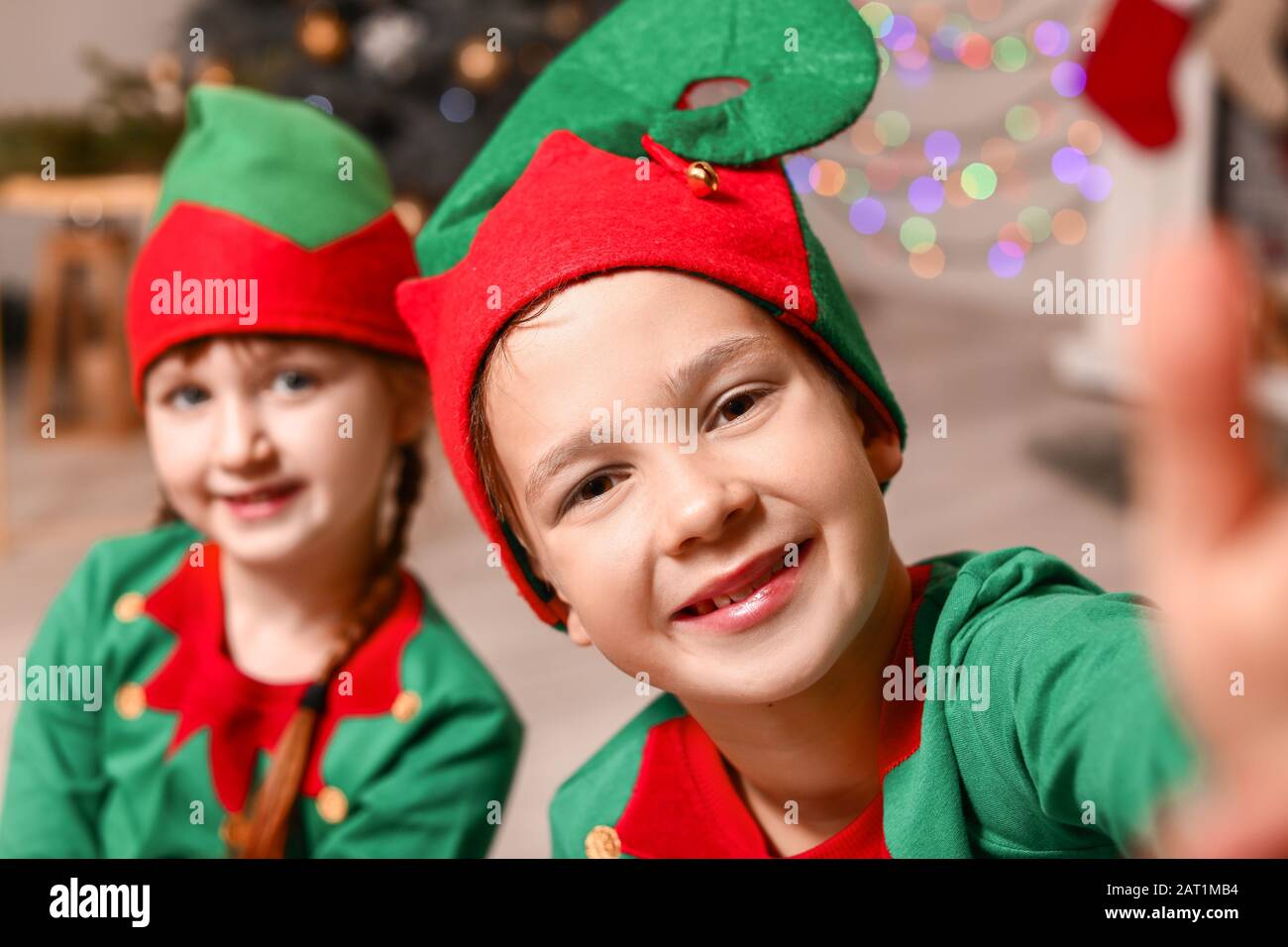 Little children in costume of elf taking selfie at home Stock Photo - Alamy