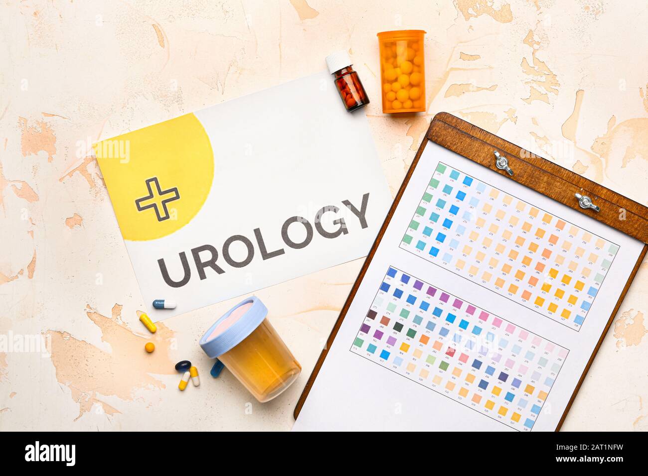 Paper sheet with text UROLOGY, pills and urine sample on light ...