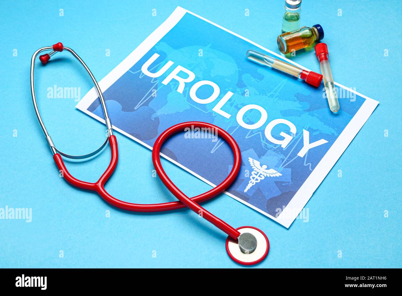 Paper sheet with text UROLOGY, stethoscope and medicines on color ...