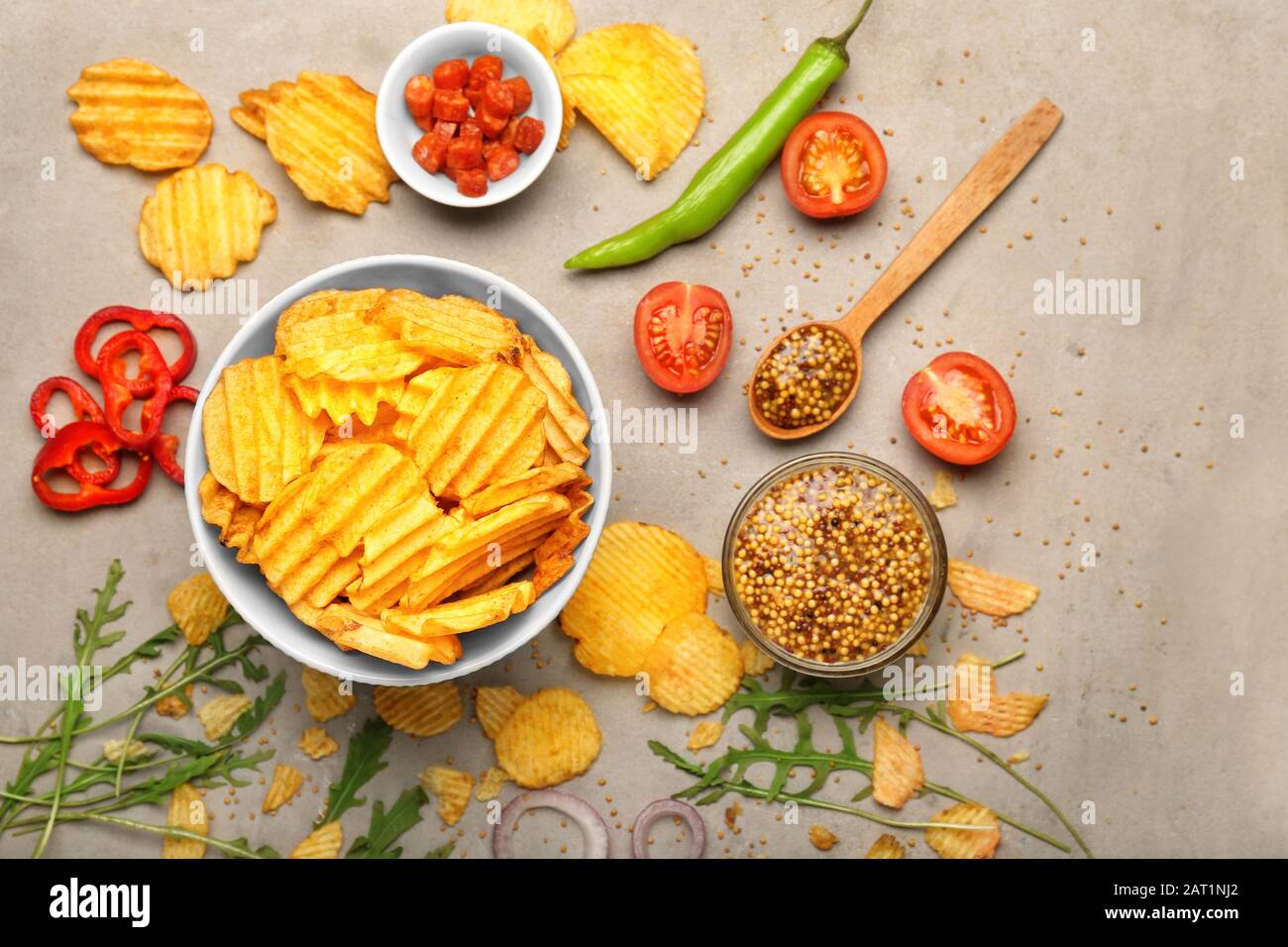 Composition with tasty potato chips on table Stock Photo - Alamy