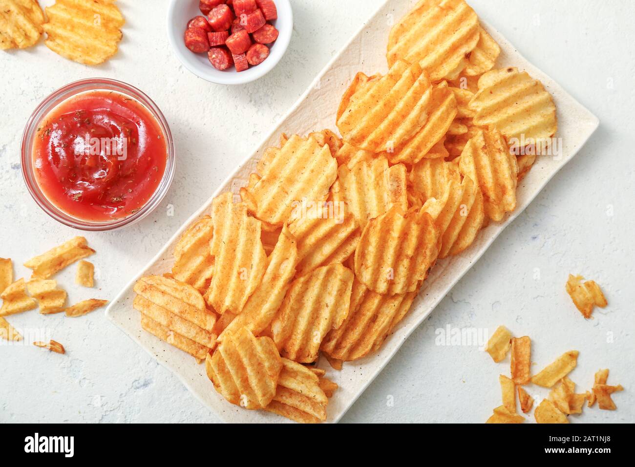 Composition with tasty potato chips on table Stock Photo - Alamy
