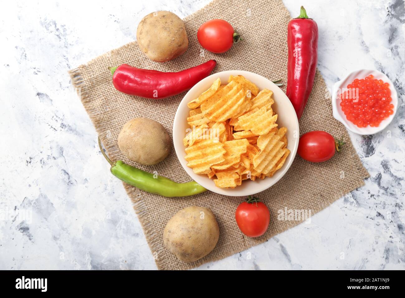 Composition with tasty potato chips on table Stock Photo - Alamy