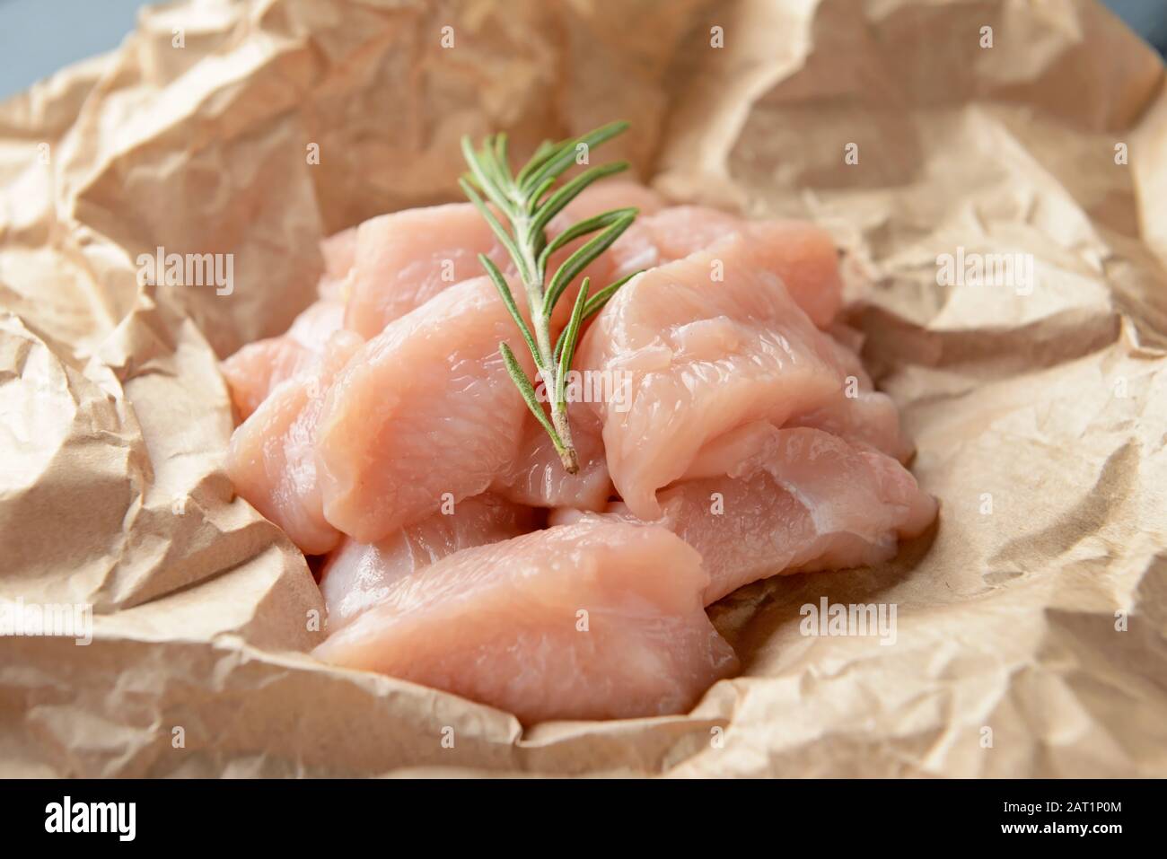 Raw cut chicken meat on parchment Stock Photo - Alamy