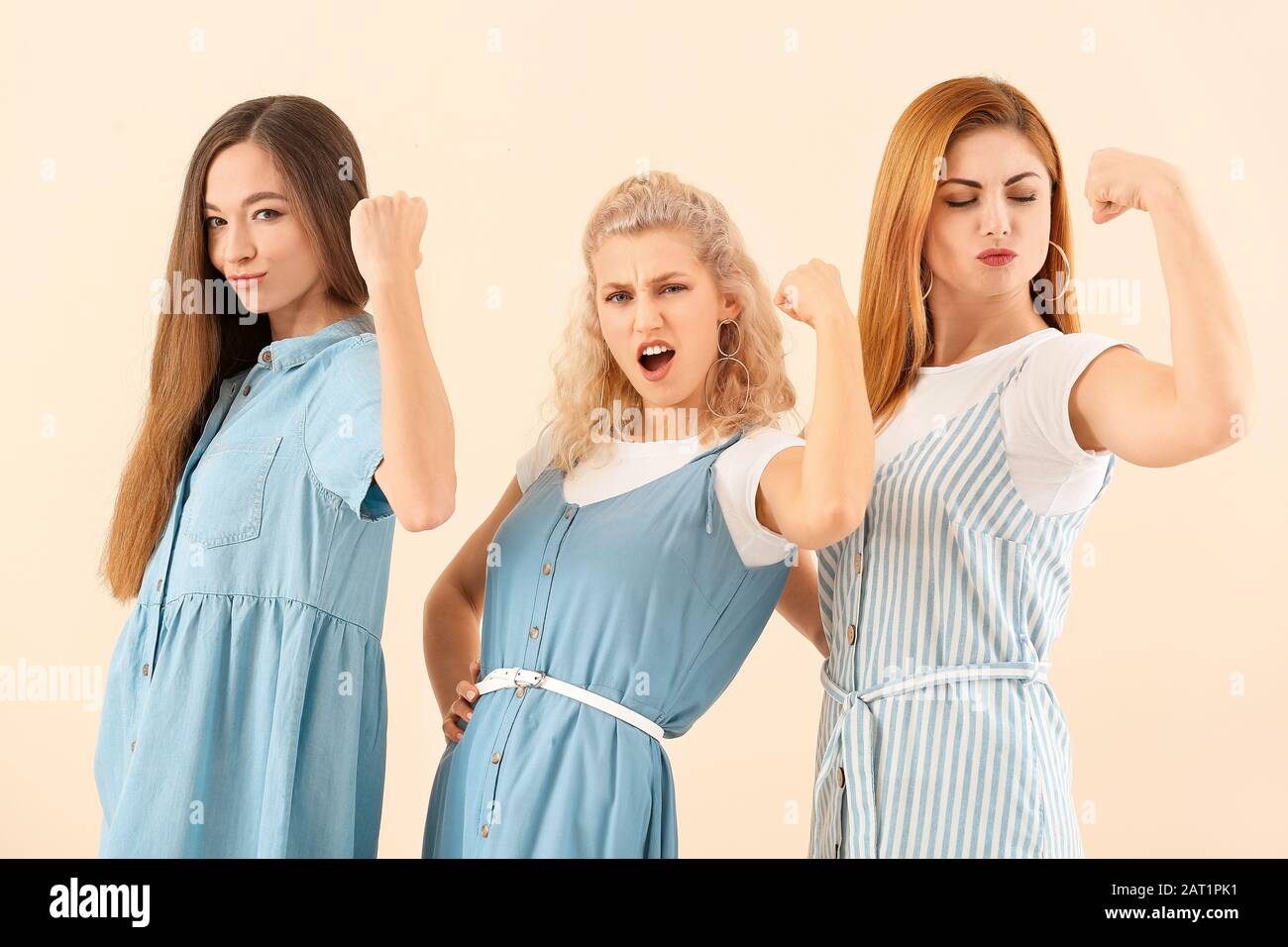 Strong young women on color background Stock Photo - Alamy