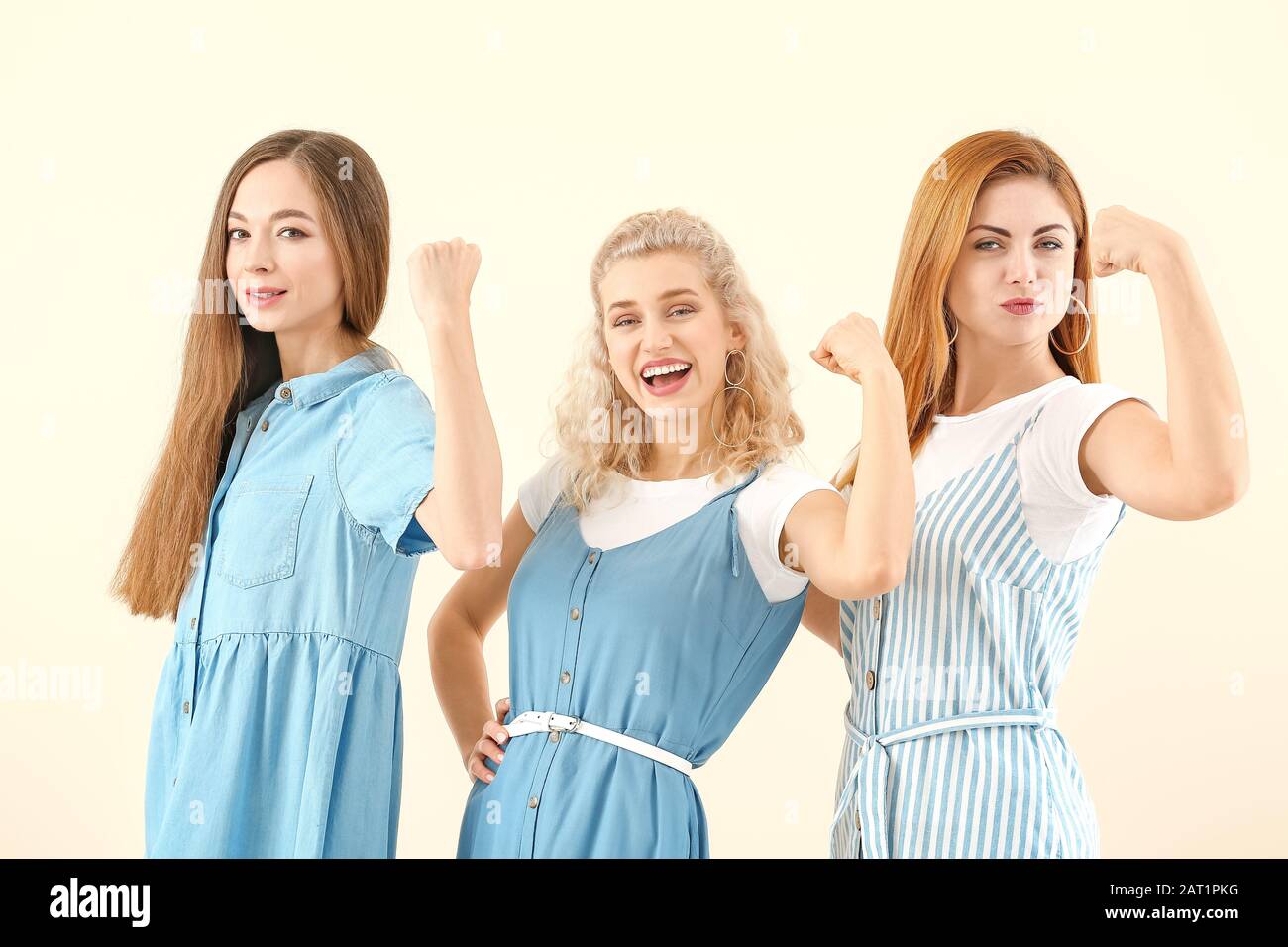 Strong young women on color background Stock Photo - Alamy