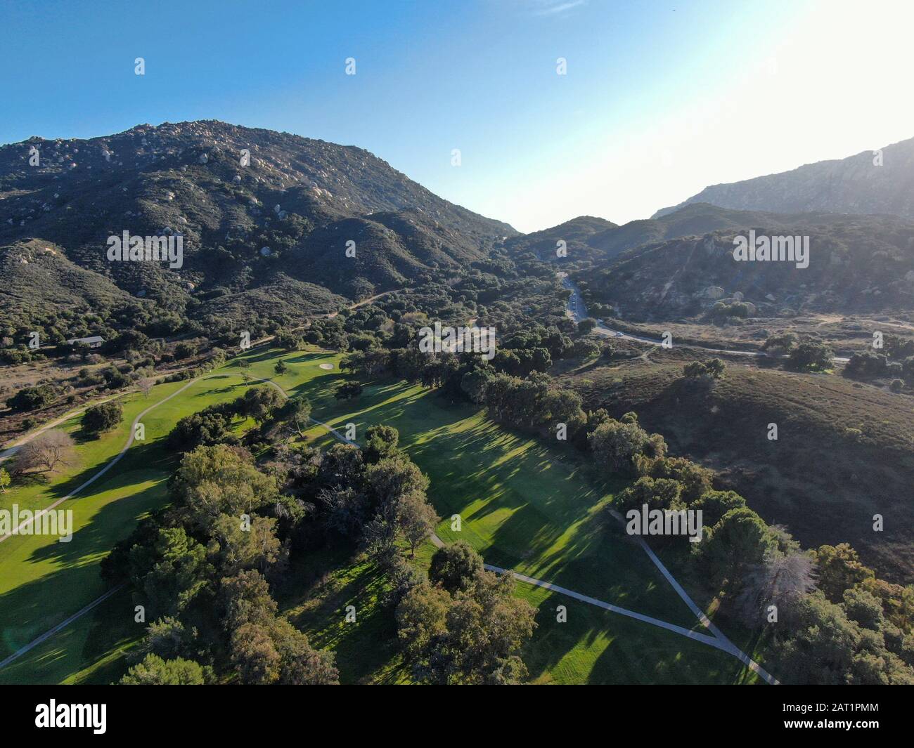 Aerial view of golf course with green field in the valley. Green turf ...