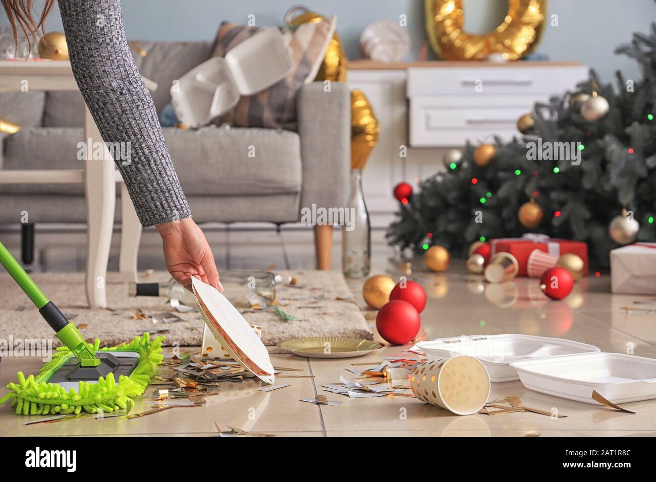 Woman cleaning up room after New Year party Stock Photo - Alamy