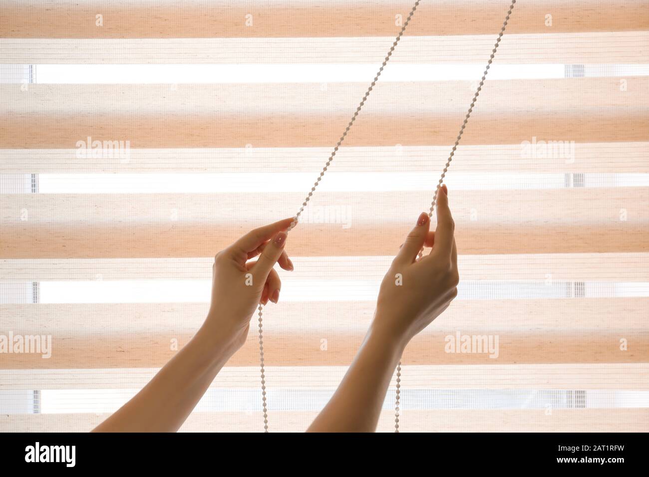 Hand closing window shade hi-res stock photography and images - Alamy