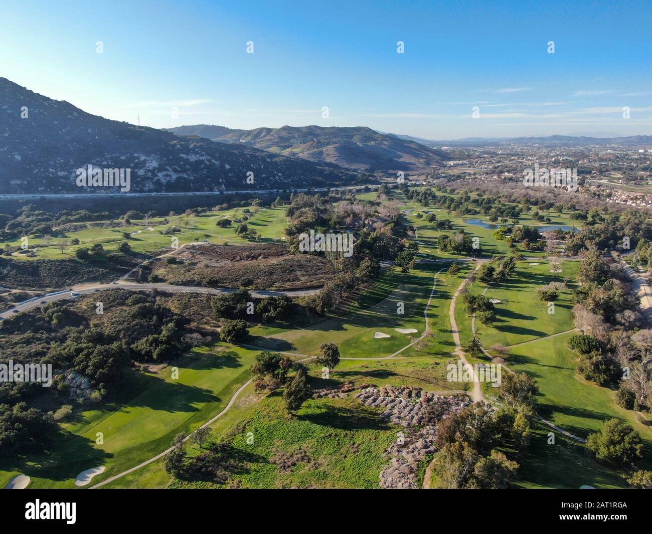 Aerial view of golf course with green field in the valley. Green turf ...