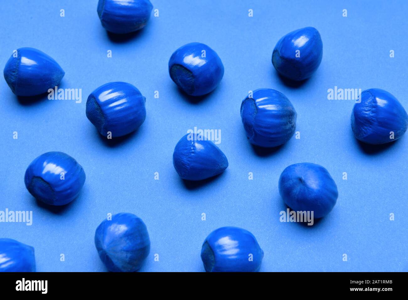Blue hazelnuts on color background Stock Photo - Alamy