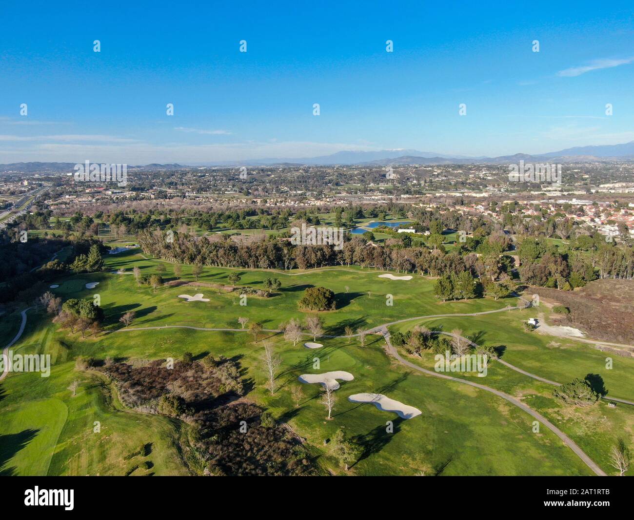 Aerial view of golf course with green field in the valley. Green turf ...