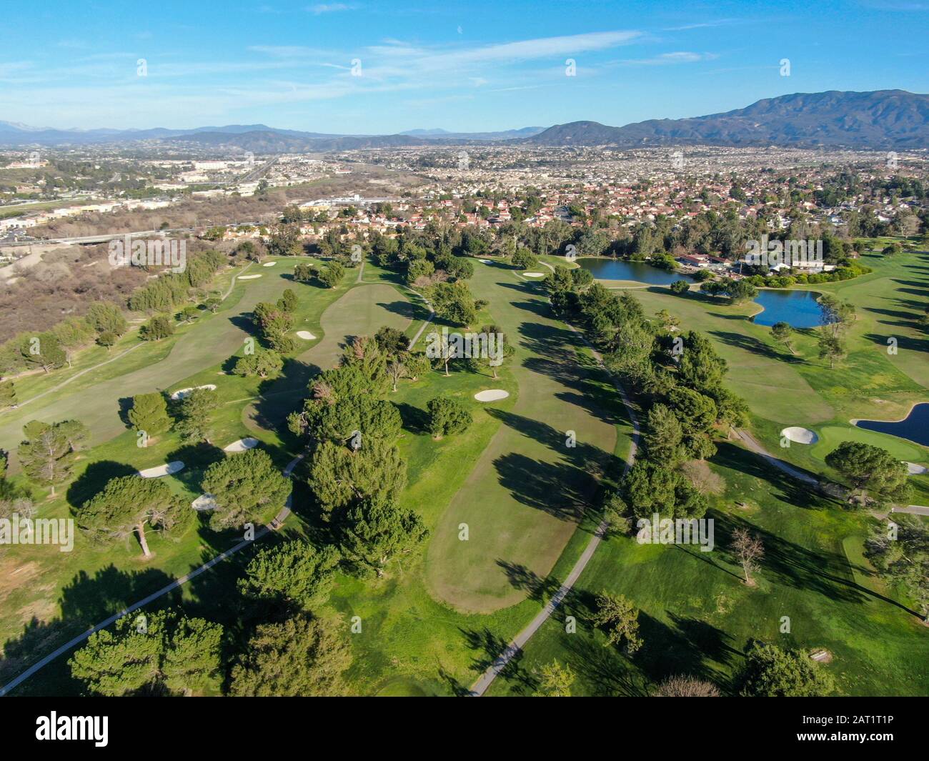 Aerial view of golf course with green field in the valley. Green turf ...