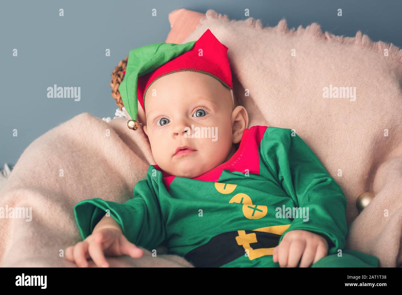 Little baby in costume of elf lying in basket Stock Photo - Alamy