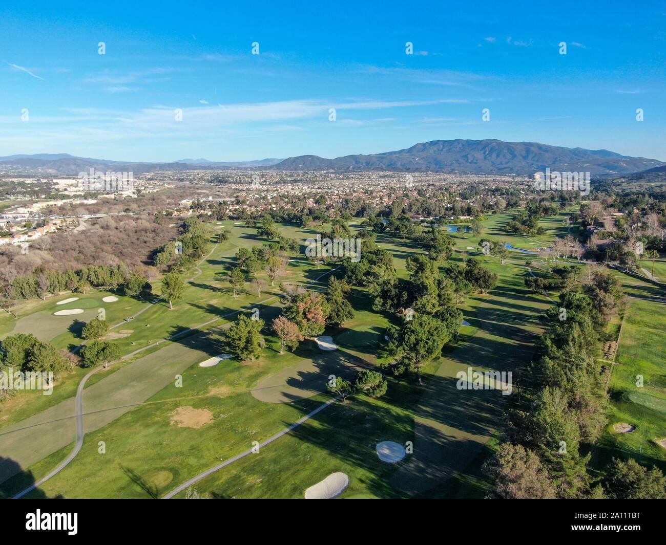 Aerial view of golf course with green field in the valley. Green turf ...