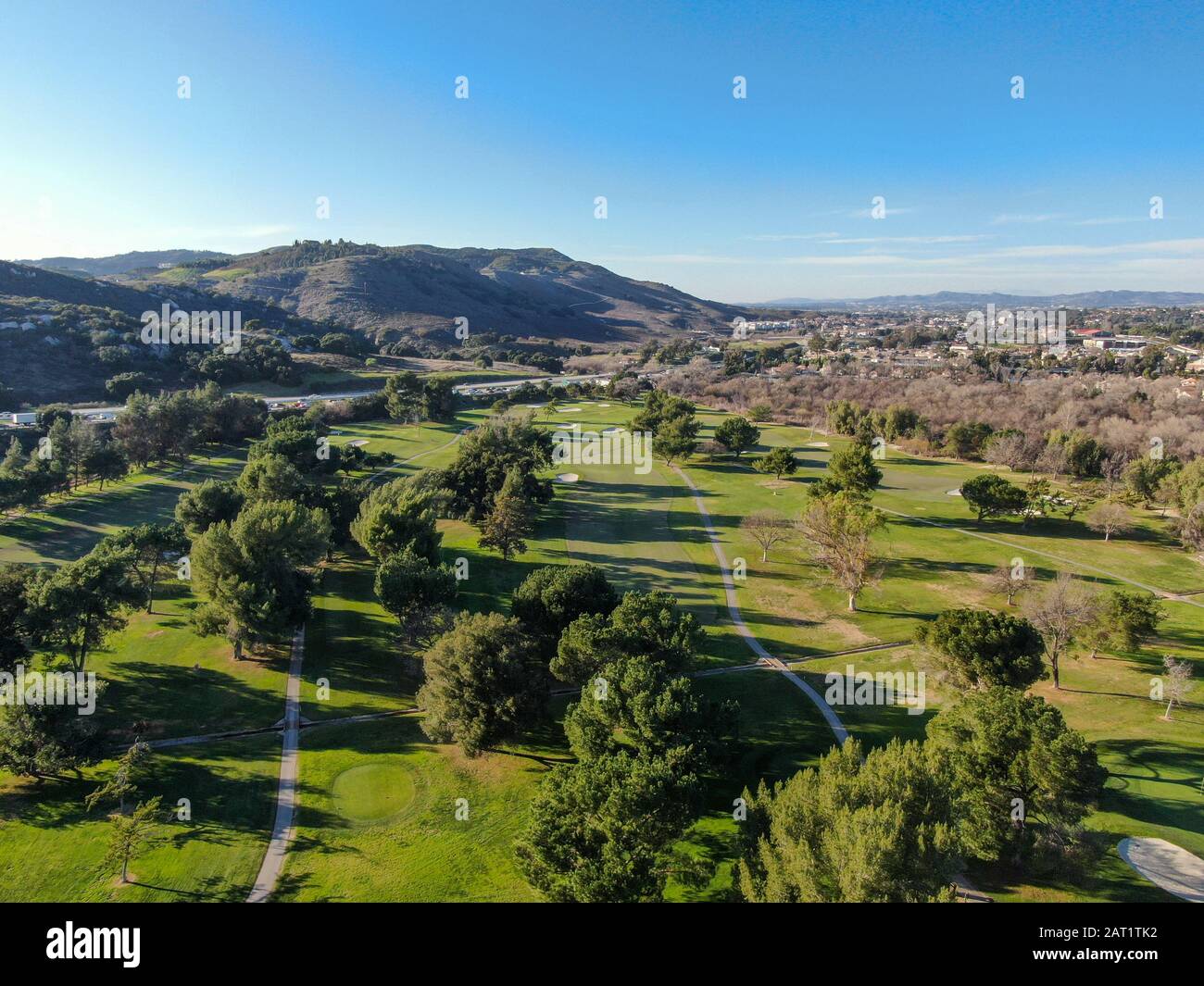 Aerial view of golf course with green field in the valley. Green turf ...