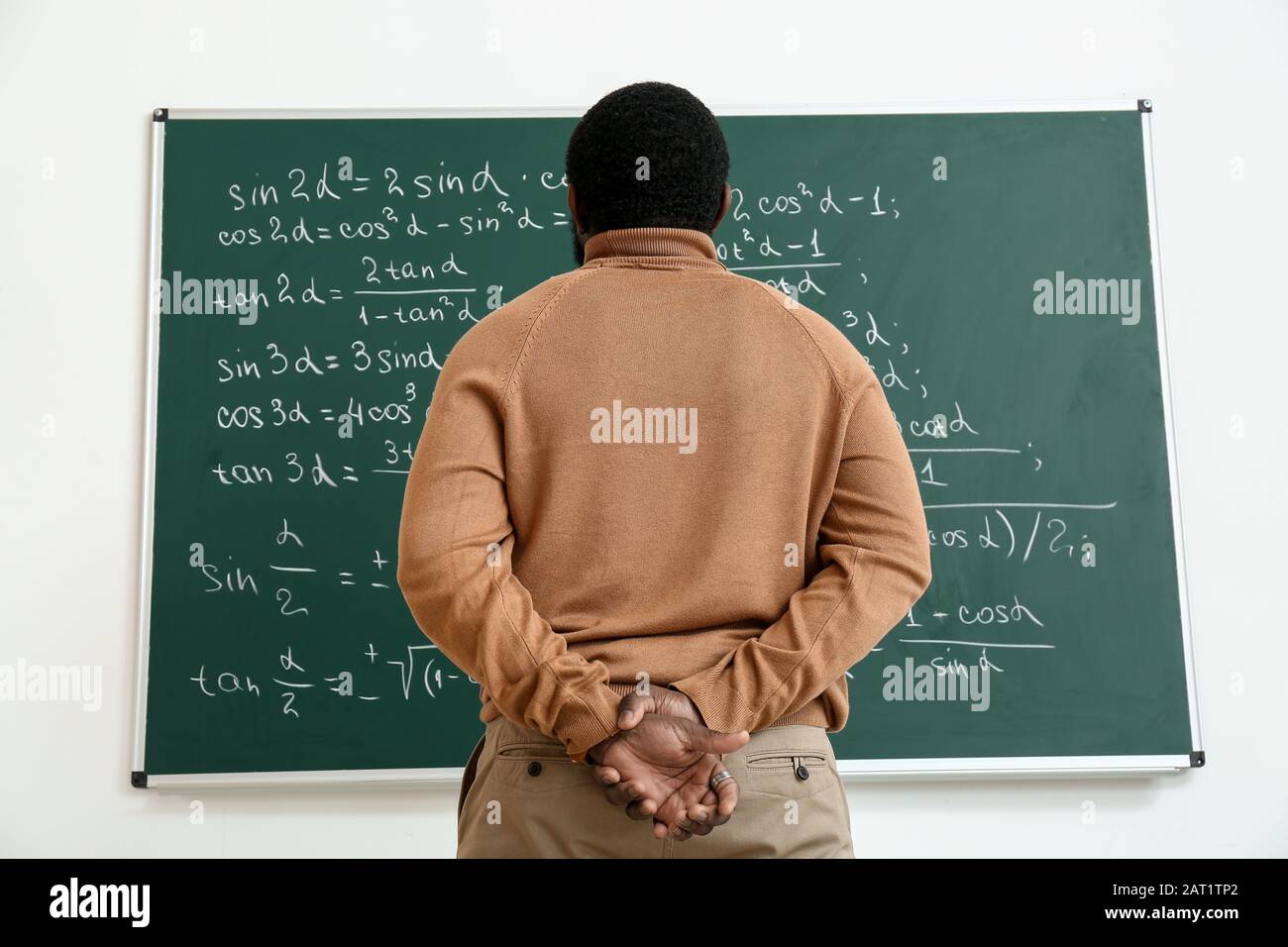 African-American math teacher near blackboard in classroom Stock Photo ...