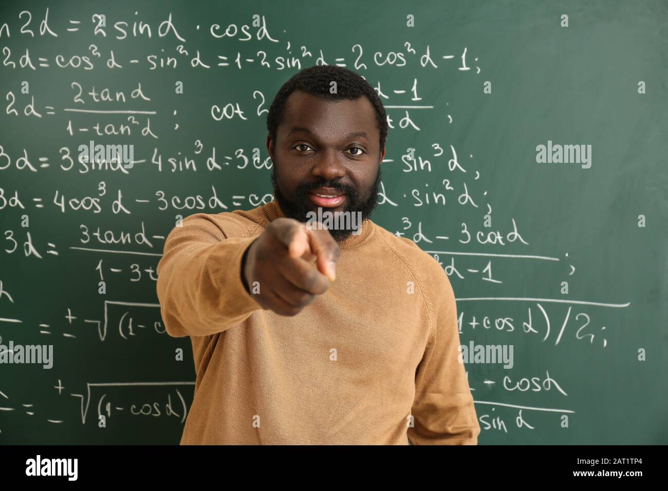 African-American math teacher near blackboard in classroom Stock Photo ...