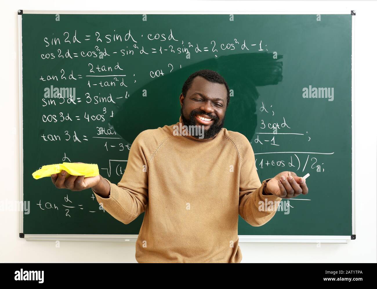 African-American math teacher near blackboard in classroom Stock Photo ...